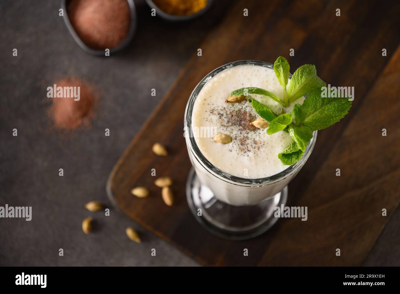 Indian Salty lassi with mint leaves and kala namak on black background ...