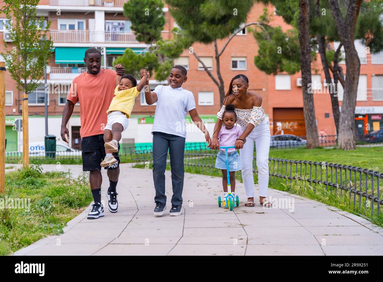 Black African ethnicity family with children at playground, smiling at ...