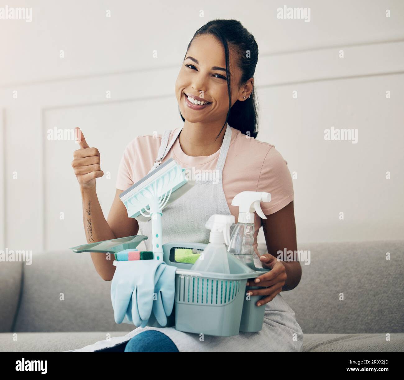 Thumbs up, portrait of a woman with cleaning supplies in basket and in ...