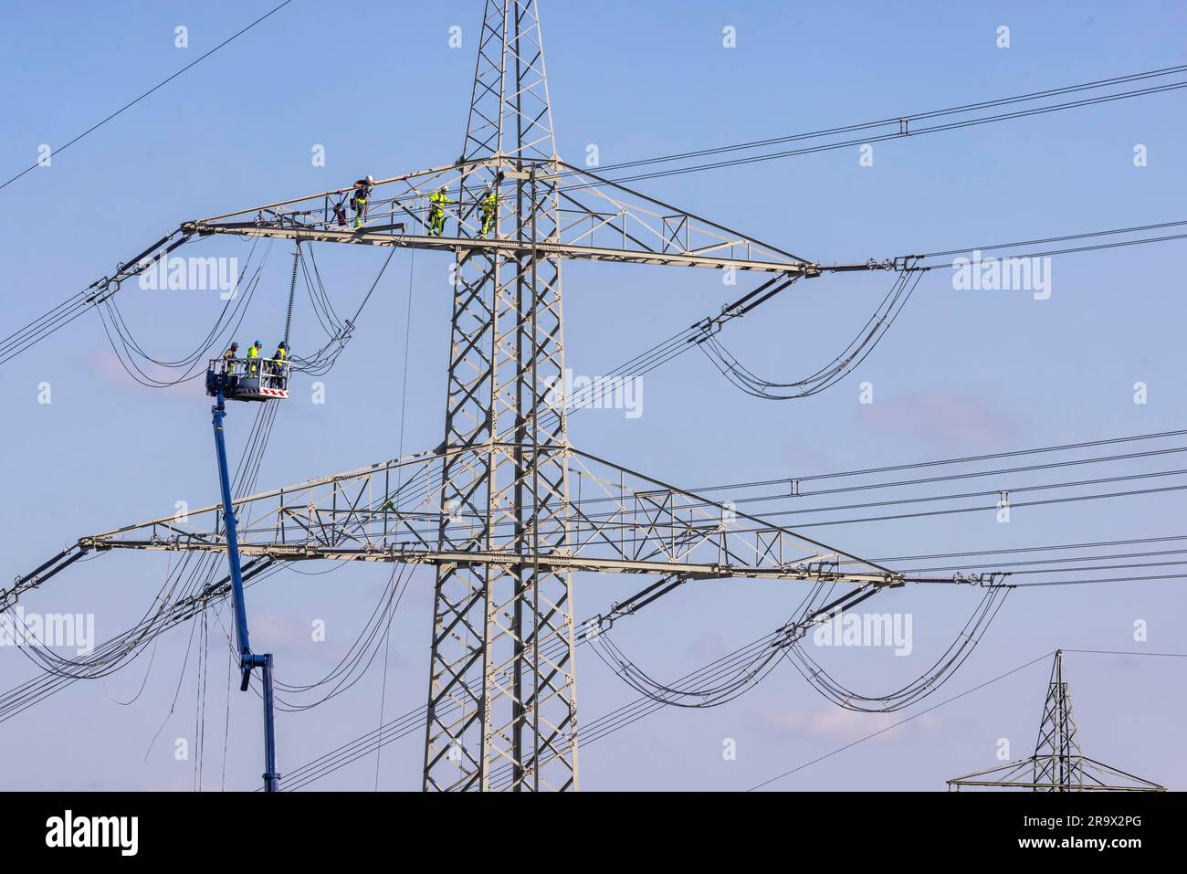 High-voltage pylon with fitters with cherry picker, Bad Wildungen ...