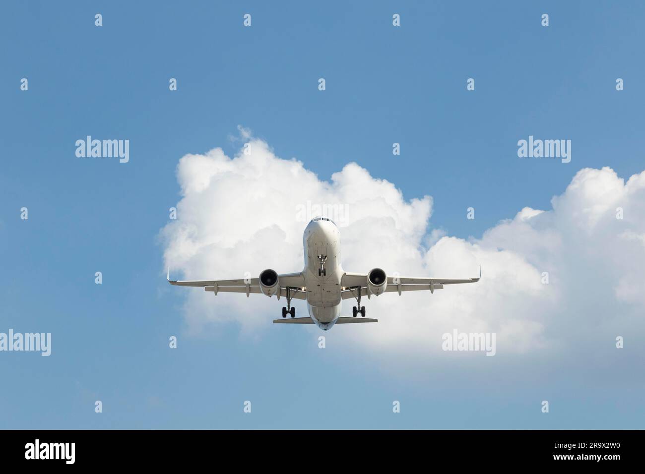 Passenger aircraft against a blue sky on approach to Hamburg Airport ...