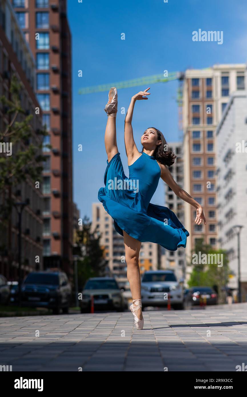 Beautiful Asian ballerina dancing outdoors. Urban landscape Stock Photo - Alamy