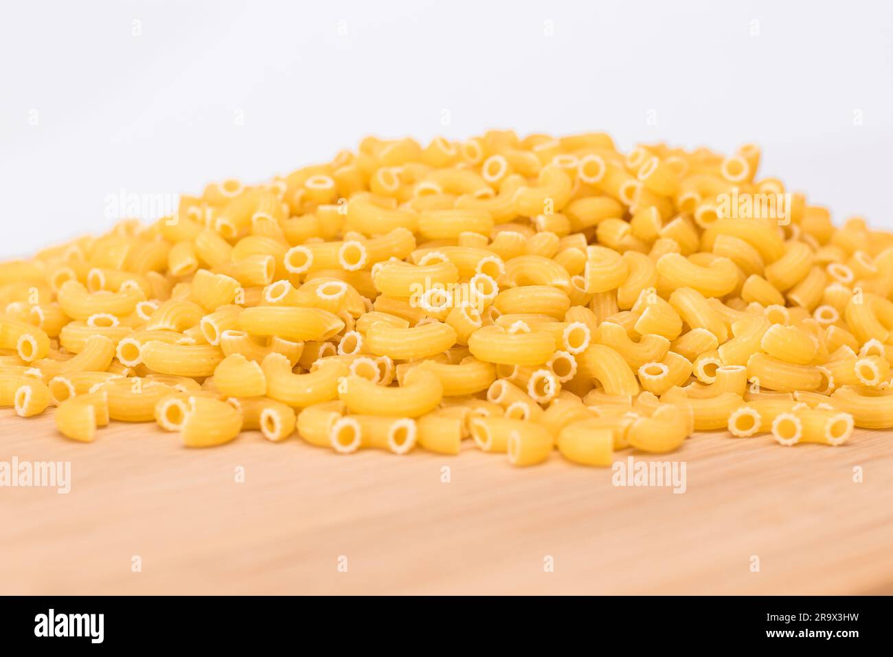 A Heap of Uncooked Chifferi Rigati Pasta on Wooden Kitchen Board. Fat ...