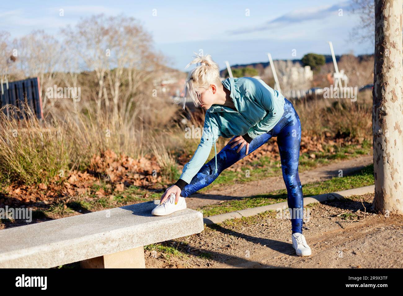beautiful woman personal trainer stretching her legs outdoors Stock ...