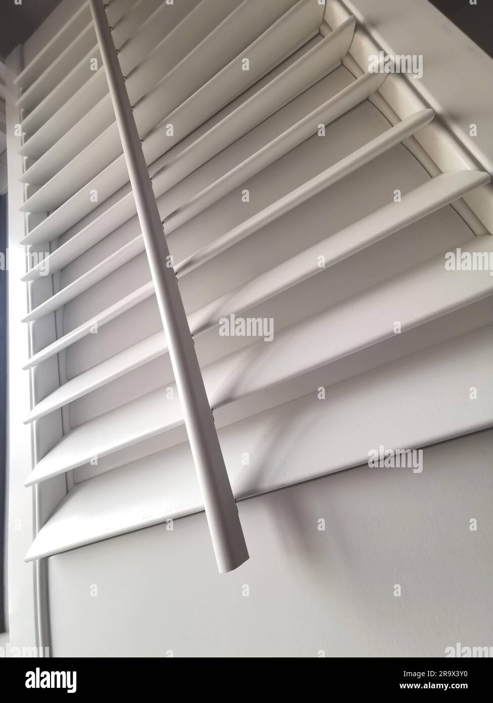 Vertical angled image of light shining through white plantation ...