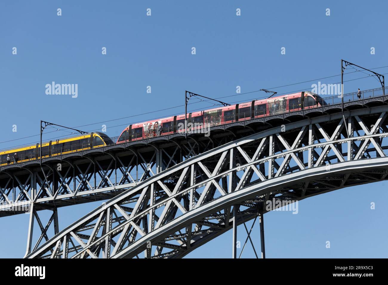Metro do Porto train crossing the Ponte D. Luis I truss arch bridge ...