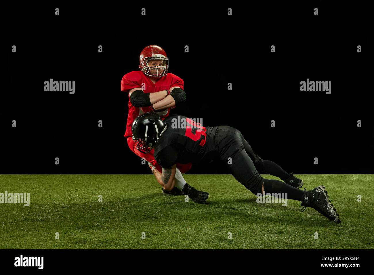 Competitive spirit. Two men, american football players in full uniform ...