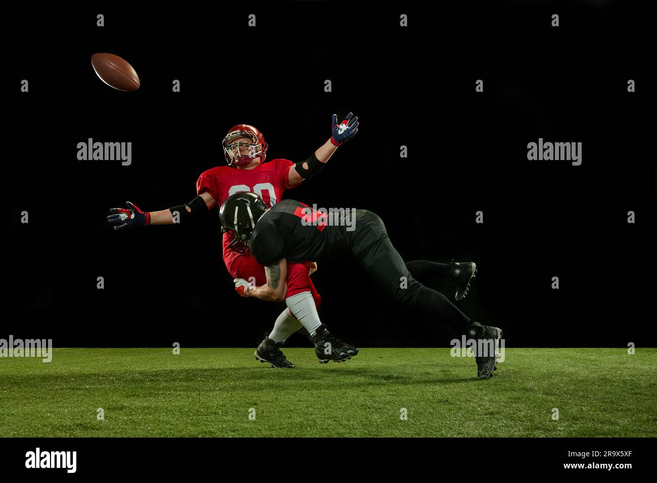 Defender. Two men, american football players in full uniform and ...