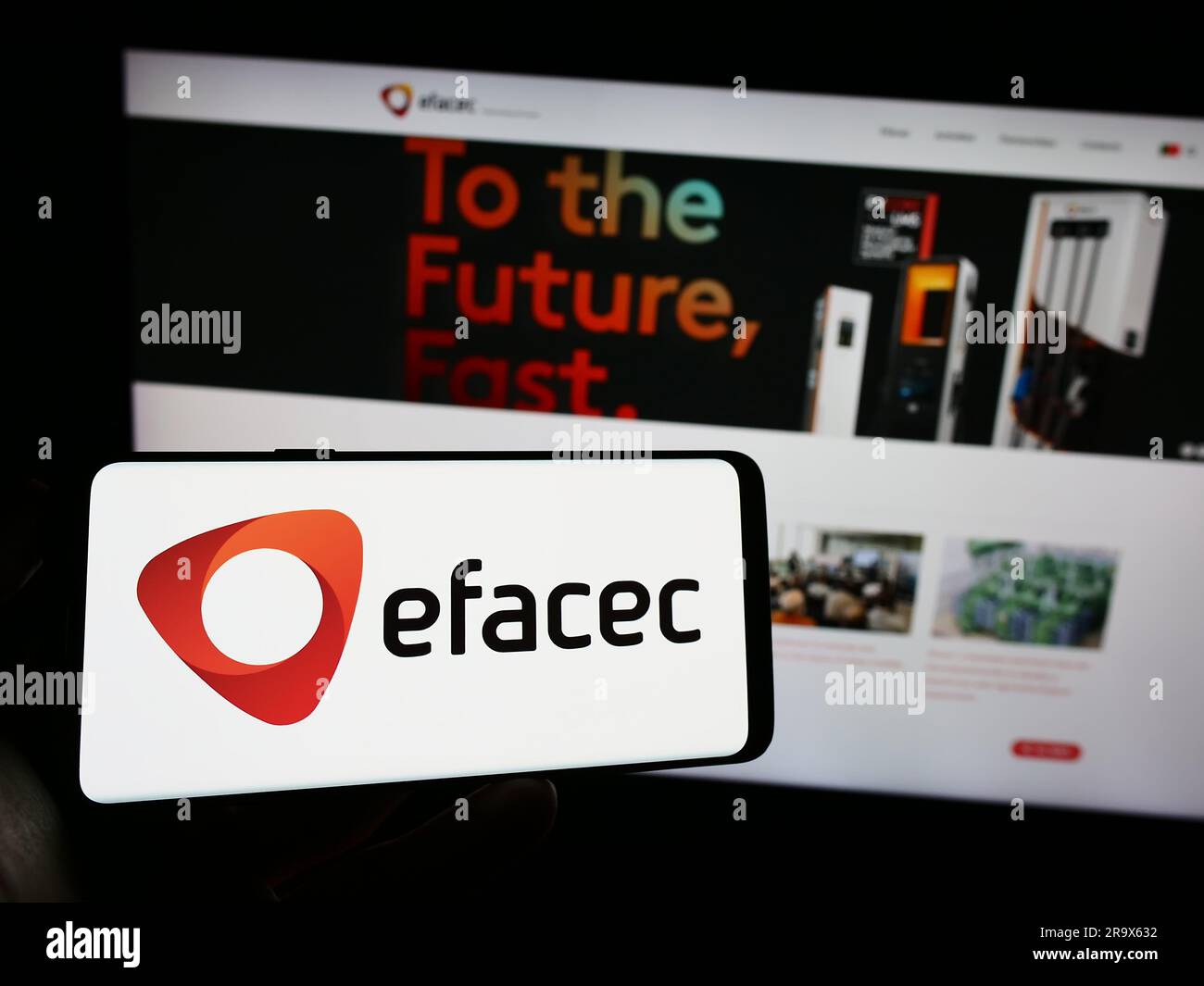 Person holding cellphone with logo of energy company EFACEC Power ...