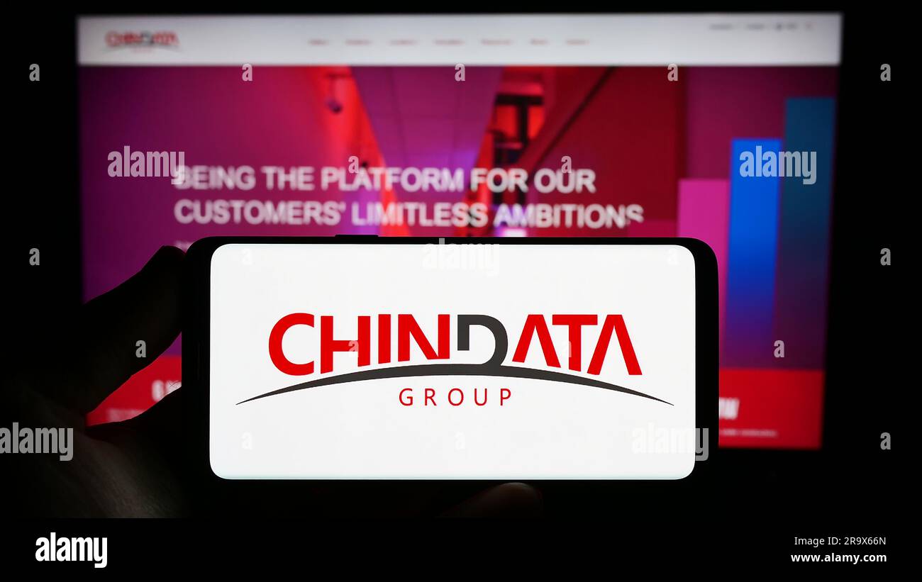 Person holding smartphone with logo of Chinese data center company ...