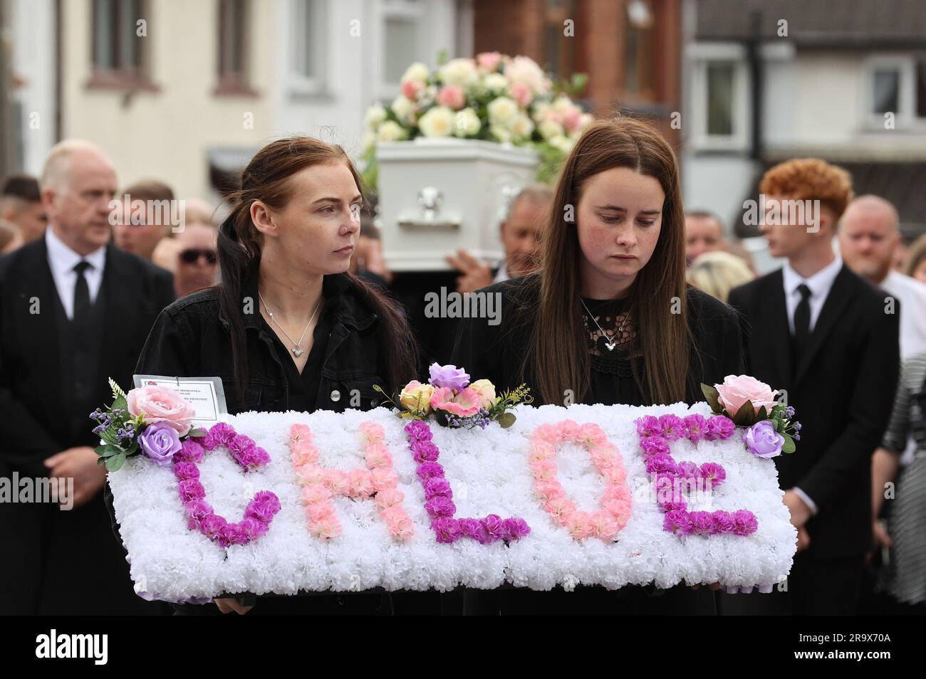 Chloe Mitchell's sisters Kirsty (left) and Nadine carry a wreath in ...