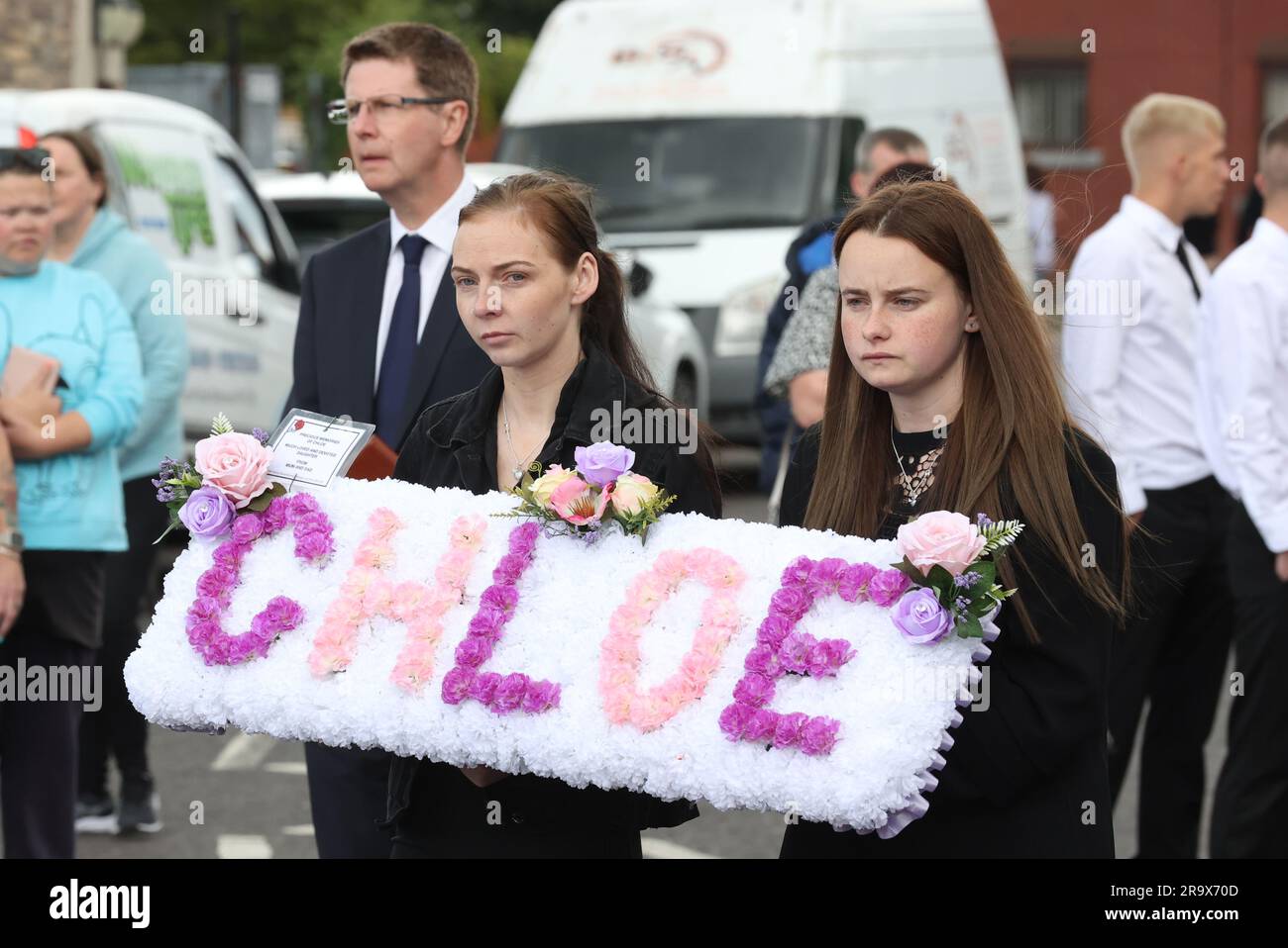 Chloe Mitchell's sisters Kirsty (left) and Nadine carry a wreath in ...