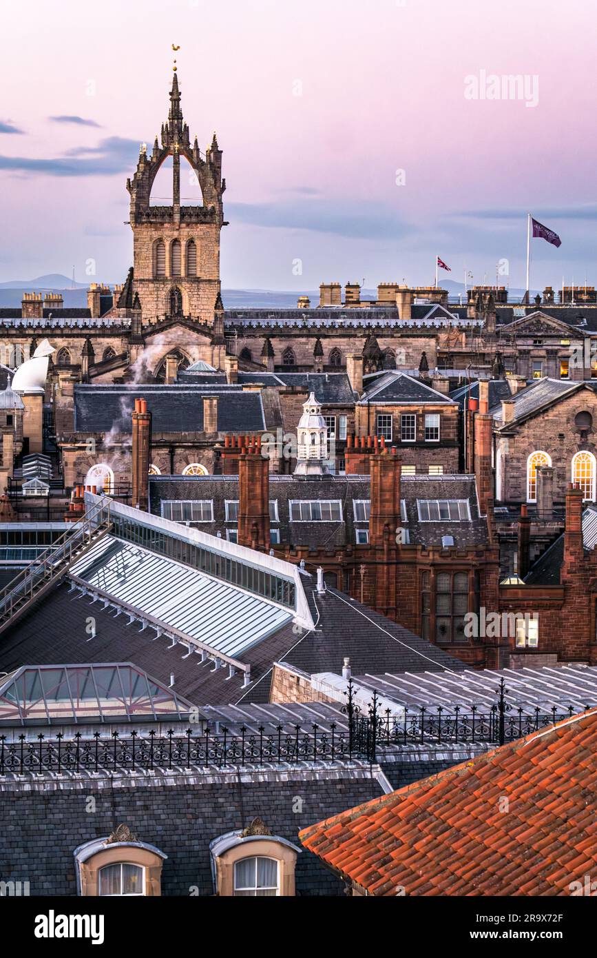 Sunset view of Edinburgh rooftops skyline to church spire of St Giles ...