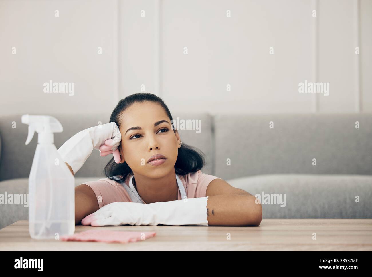 Mental health, woman thinking and busy cleaning in her living room of ...