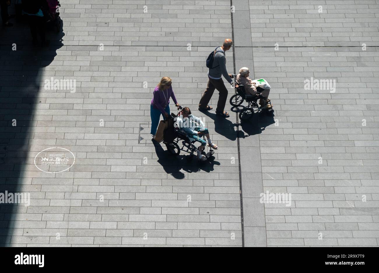Two elderly people being pushed in wheelchairs in Liverpool One ...