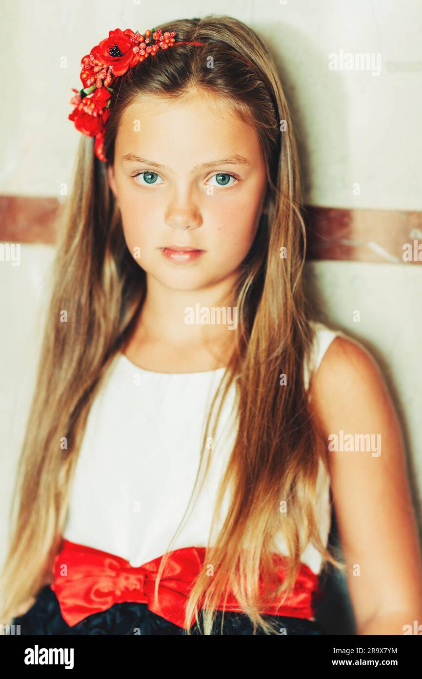 Portrait of young girl model wearing black and white dress with red ...