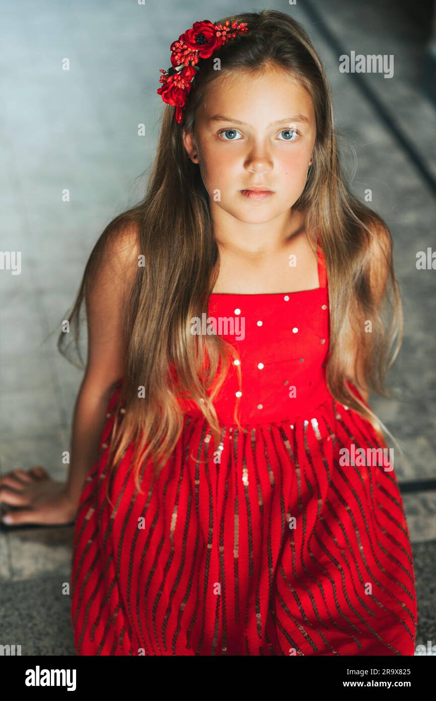Portrait of young girl model wearing red dress Stock Photo - Alamy