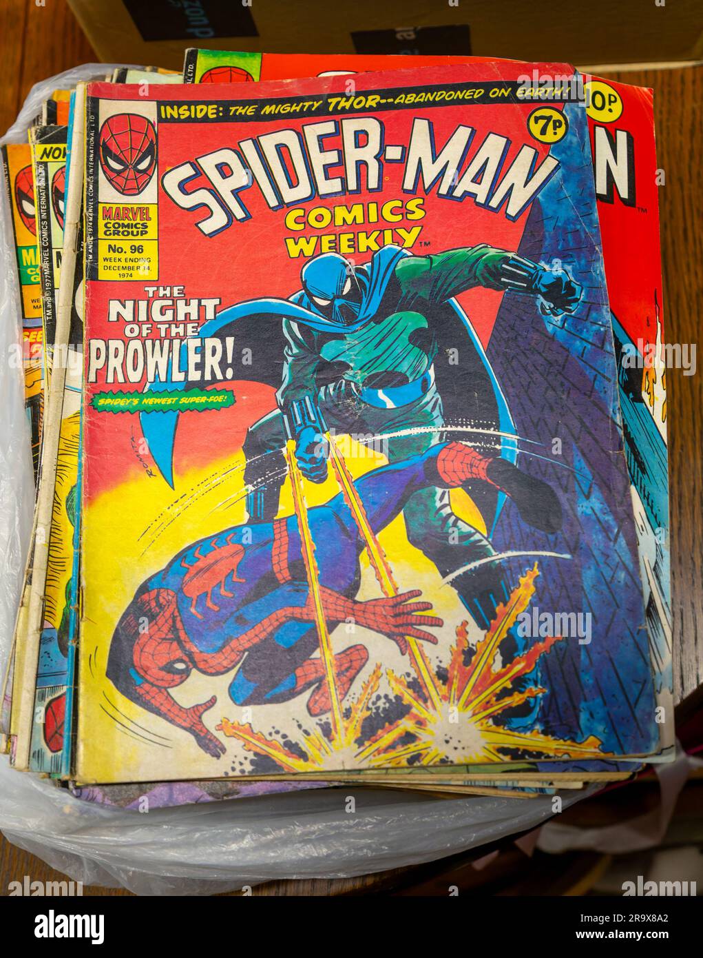 Box of Spider-Man comics on display in auction room, UK Stock Photo - Alamy