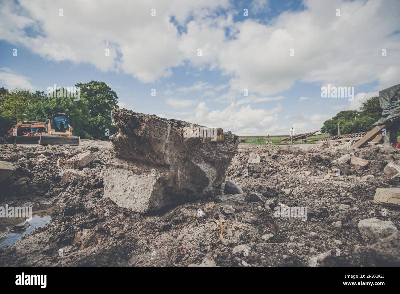 Big rock at a construction site with a excavator Stock Photo - Alamy