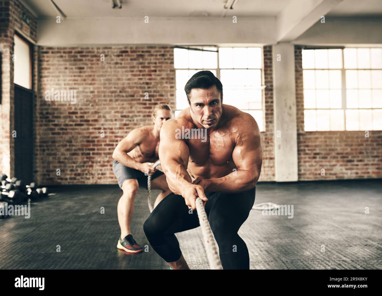 Men, gym and pull rope for workout with strong muscle, coaching and ...