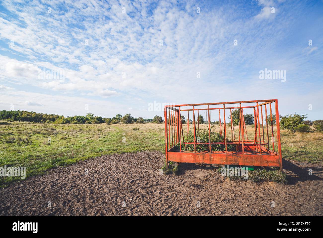 Rural landscape with a cage on a field in the summer Stock Photo - Alamy