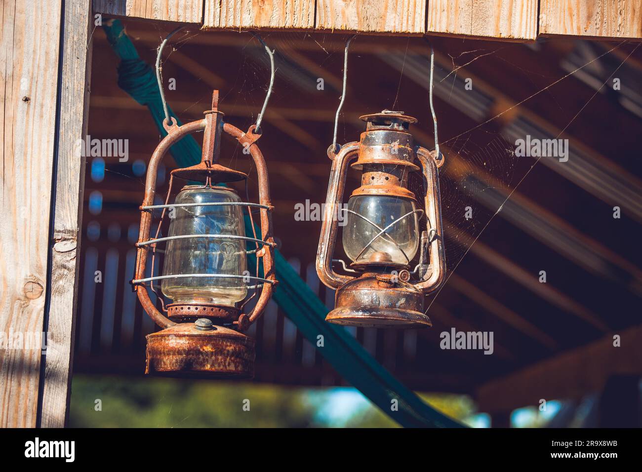 Vintage lanterns hanging in an old barn in the wild west Stock Photo ...