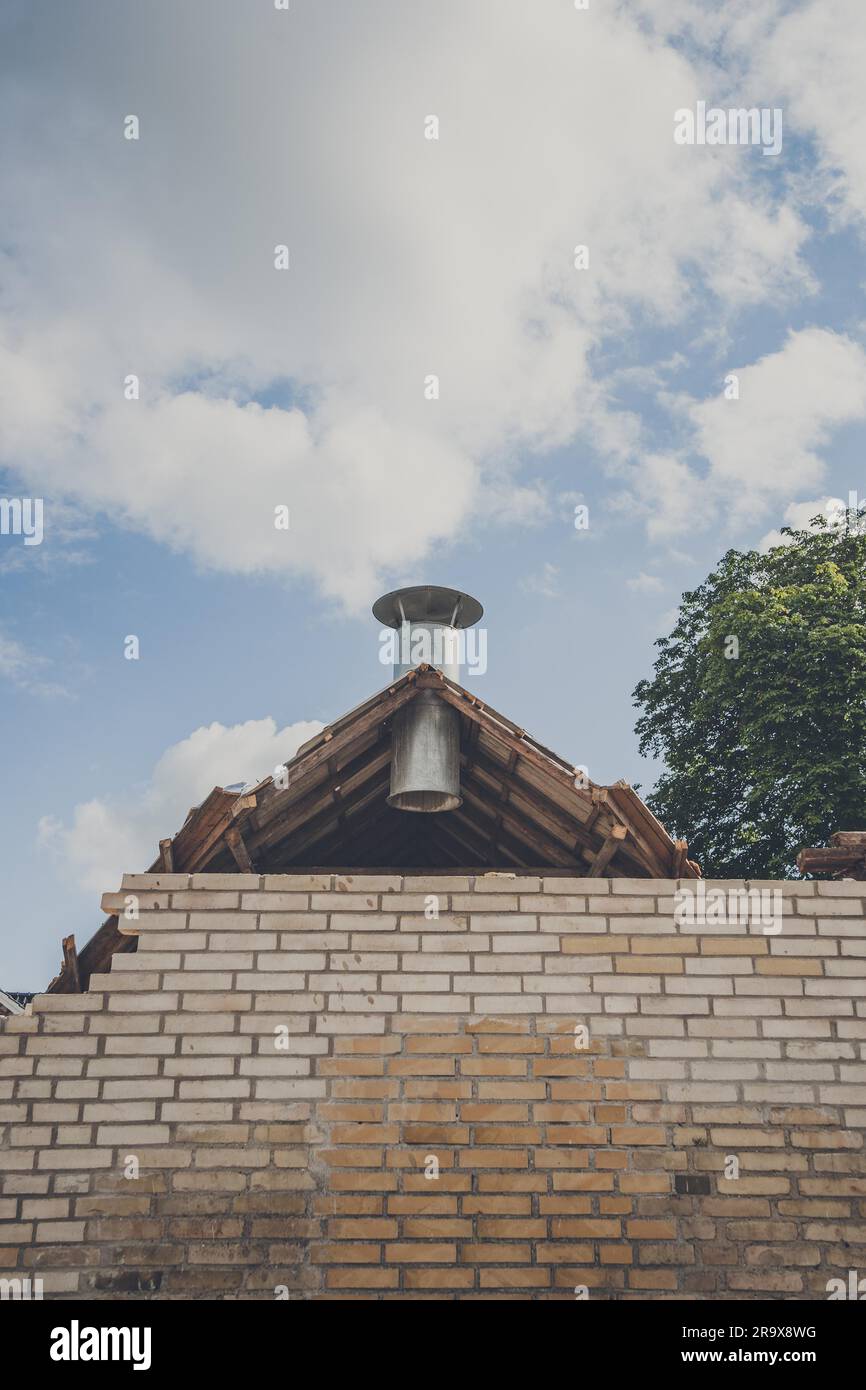 Steel chimney at a damaged building in blue sky Stock Photo - Alamy
