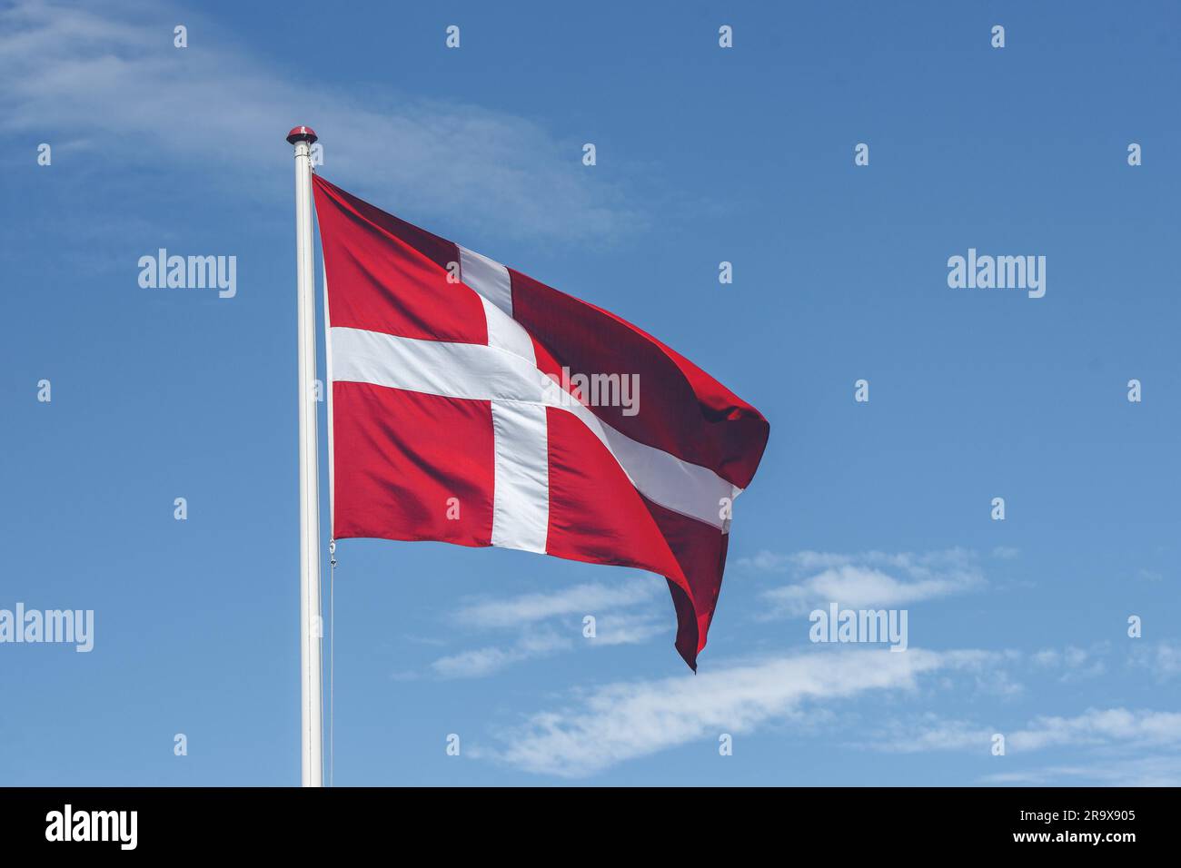 Denmark flag in red and white colors on a pole Stock Photo - Alamy