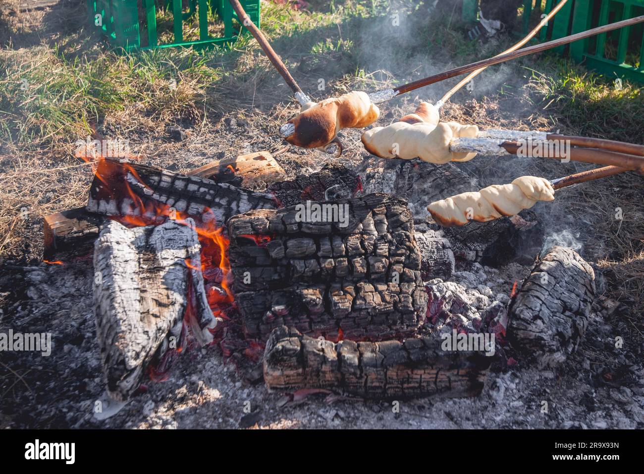 Homemade bread baked over a bonfire on wooden sticks Stock Photo - Alamy