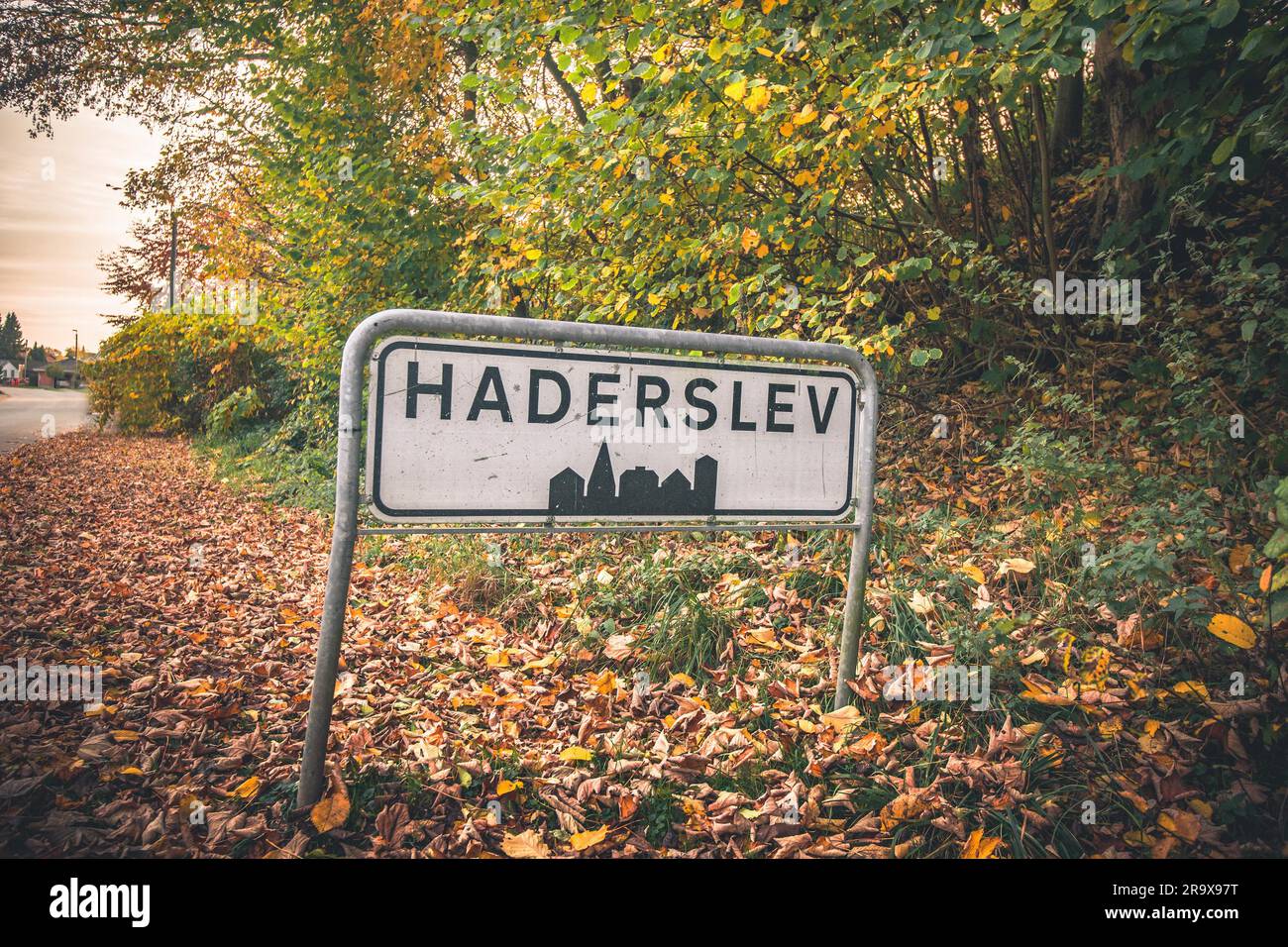 Haderslev city sign by a road in Denmark in the fall with colorful ...