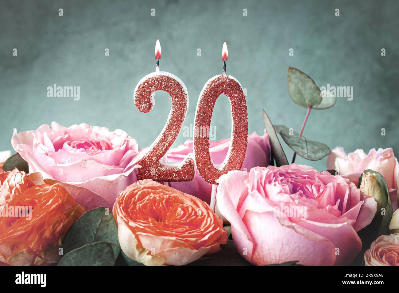 Pink glitter number 20 celebration candle with flowers Stock Photo - Alamy