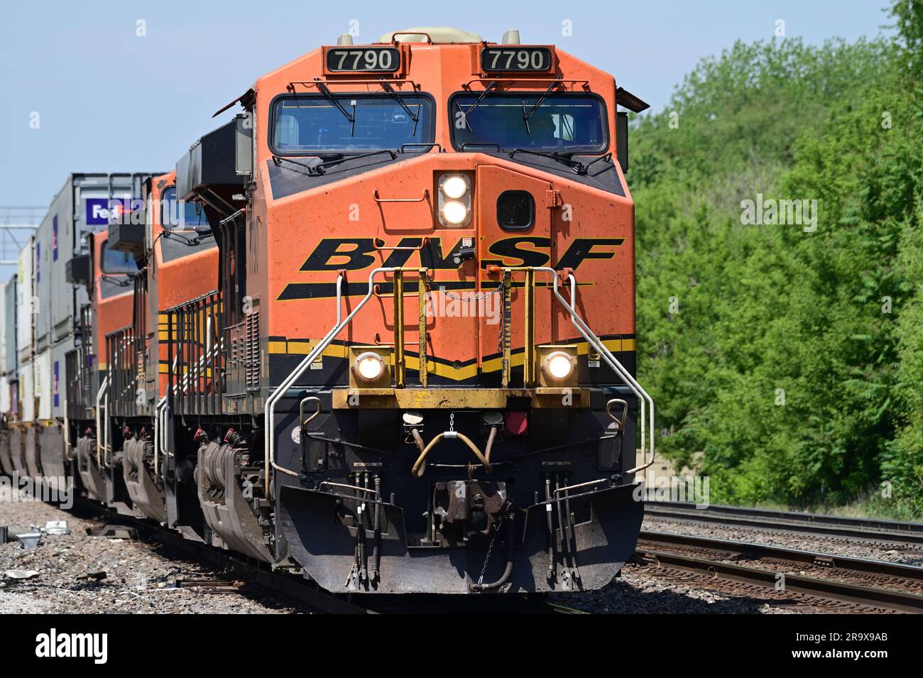 Naperville, Illinois, USA. Three Burlington Northern Santa Fe locomotives lead an intermodal ...