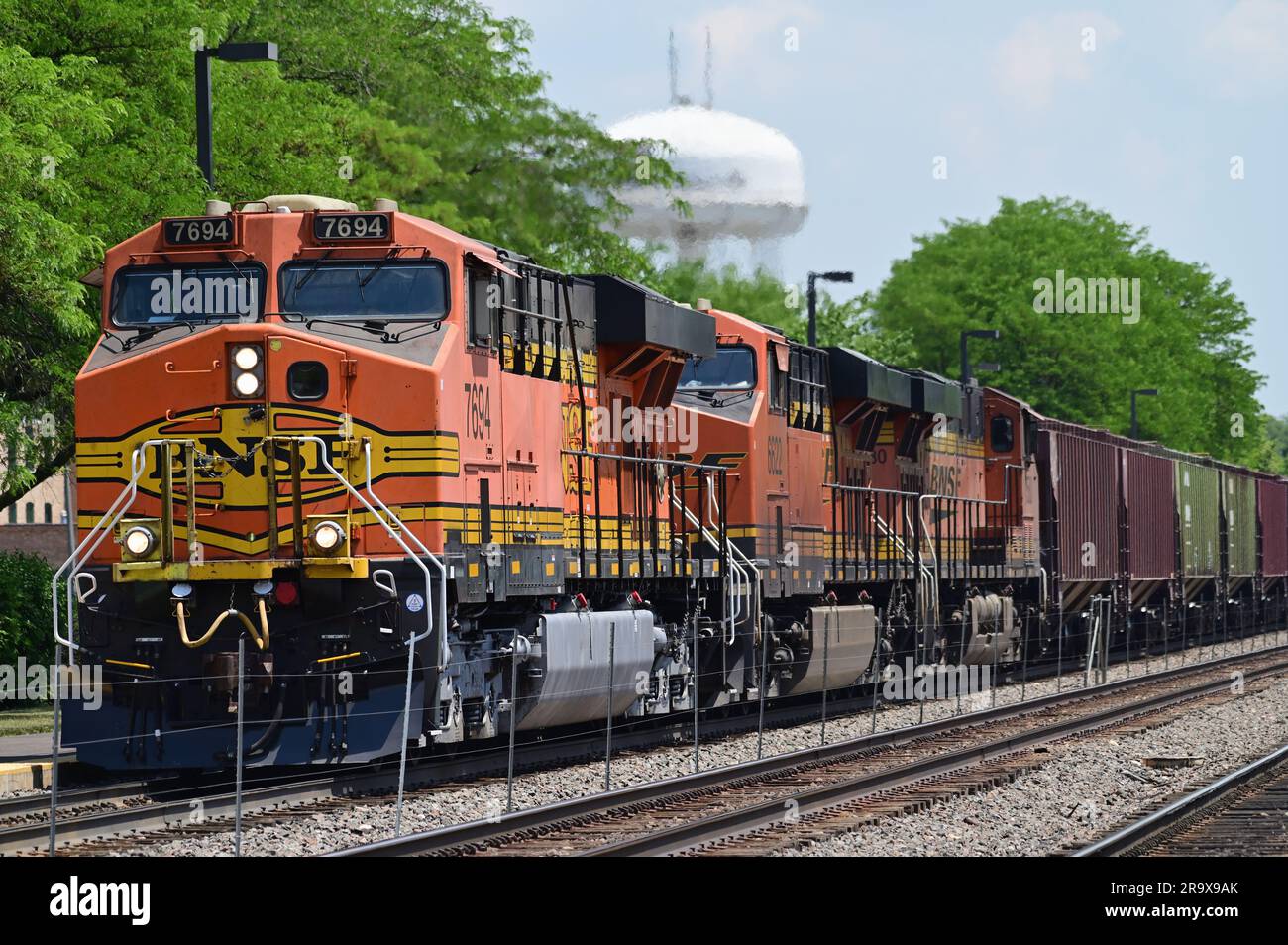 Naperville, Illinois, USA. Three locomotives lead a Burlington Northern Santa Fe freight train ...