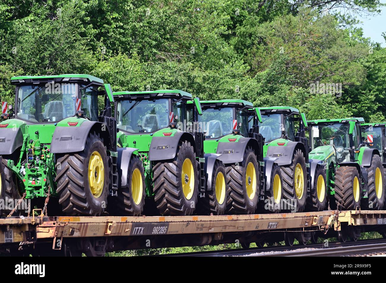 La Fox, Illinois, USA. Brand new tractors ride the rails forming part of the consist of an Union ...