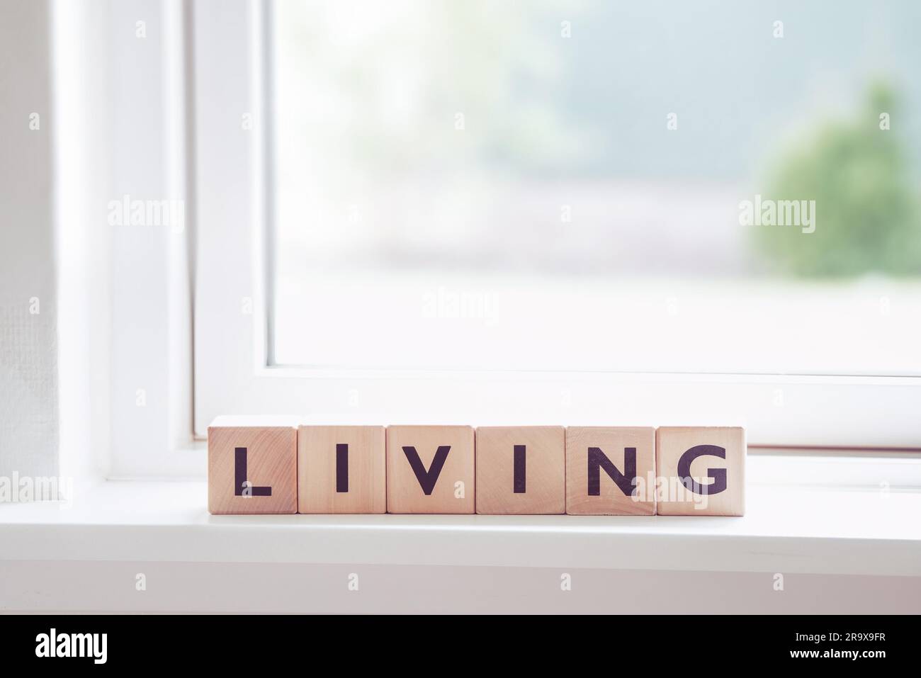 Living sign in a bright window in a room Stock Photo - Alamy
