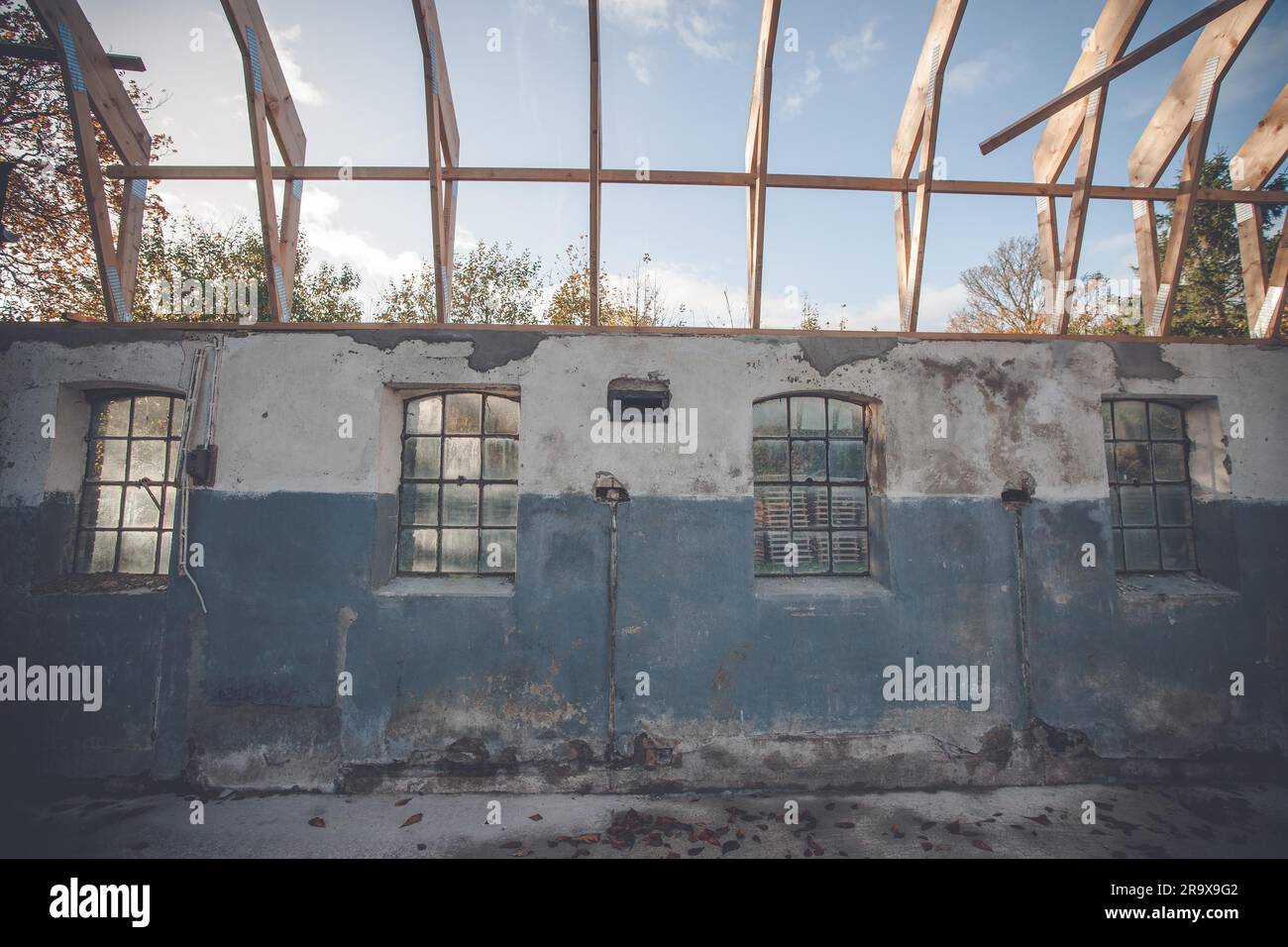 Building without a roof with grunge blue wall and old windows ready for ...
