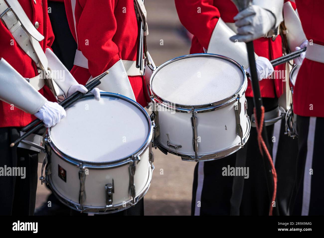 Soldiers in red uniforms with drums at a parade in the spring Stock ...