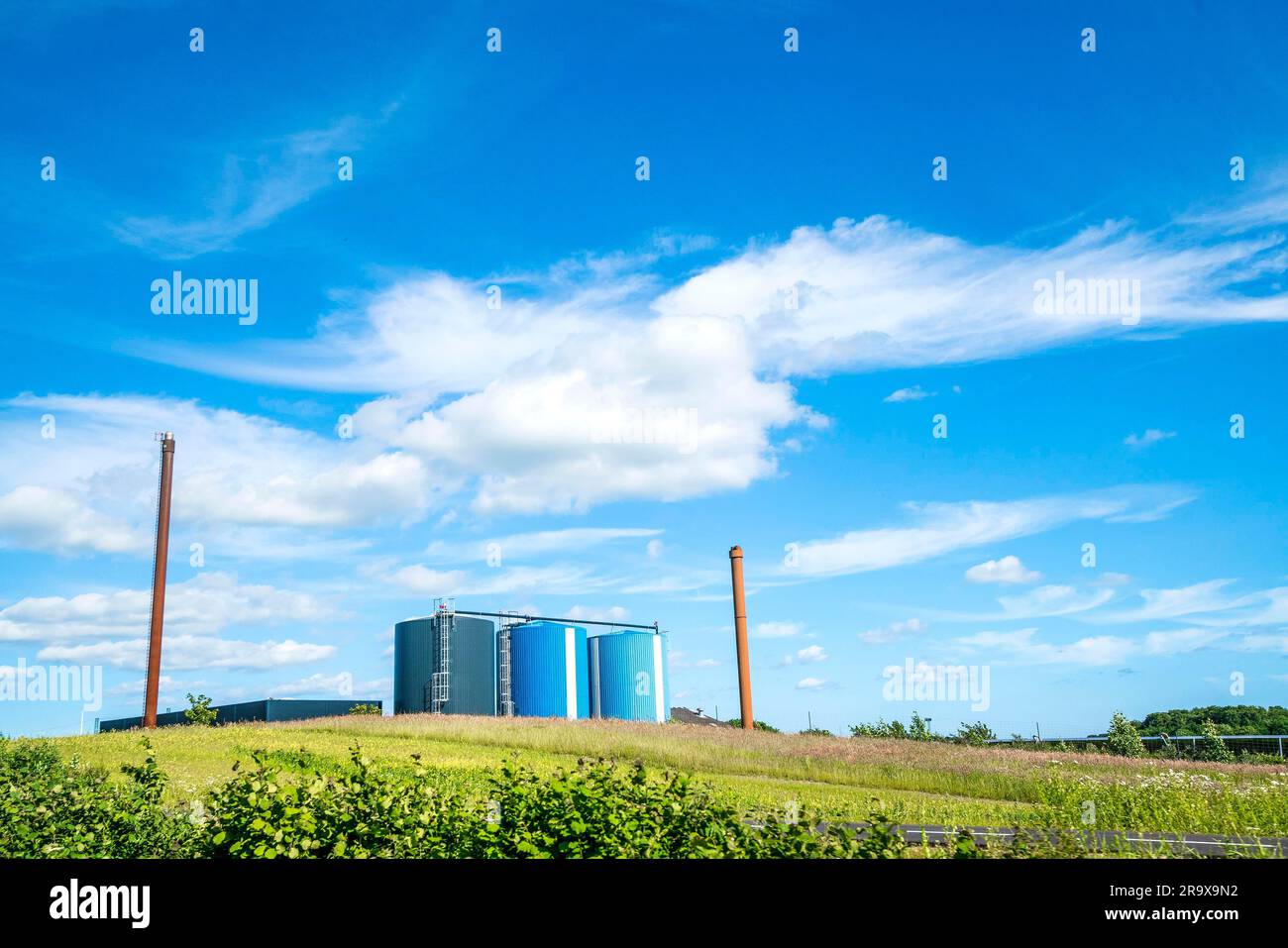 Industrial factory with large silos in blue colors and two high ...