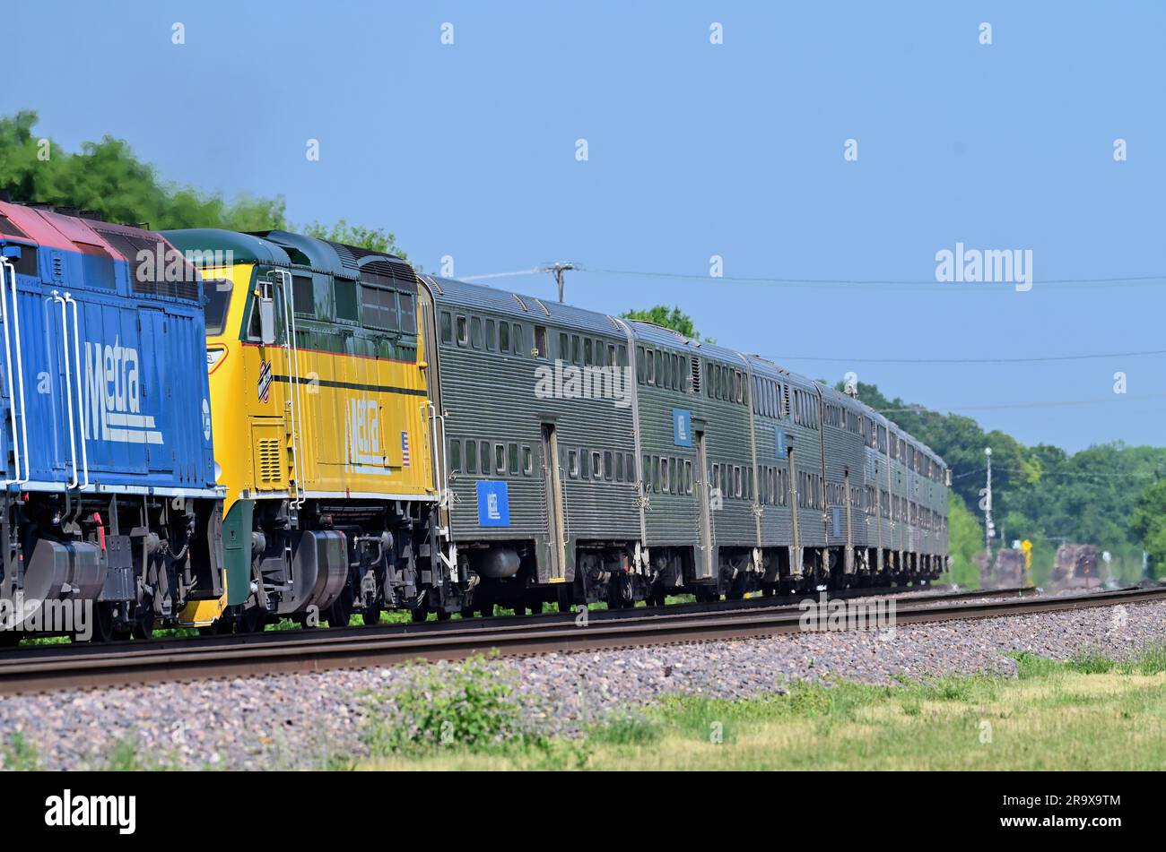 West Chicago, Illinois, USA. A Metra commuter train being pushed by two ...