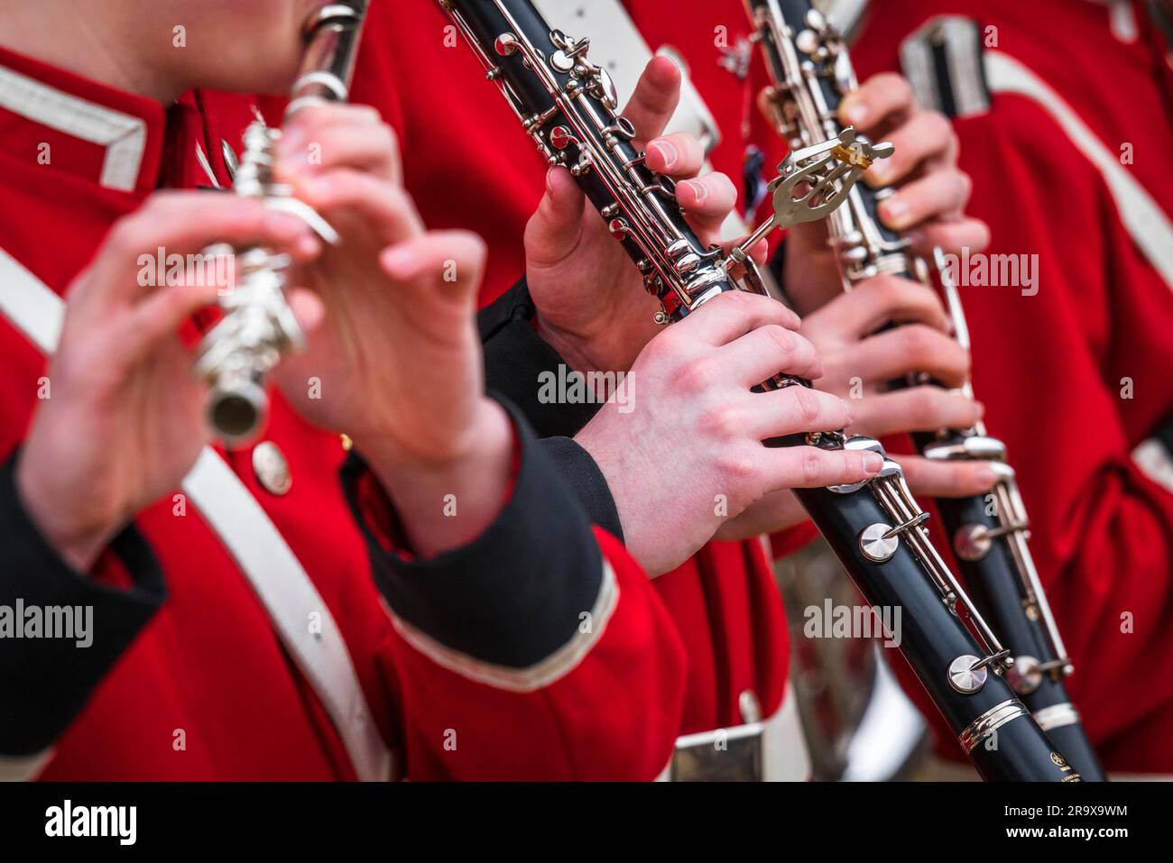 Clarinet musicians in red uniform playing playing music on their ...