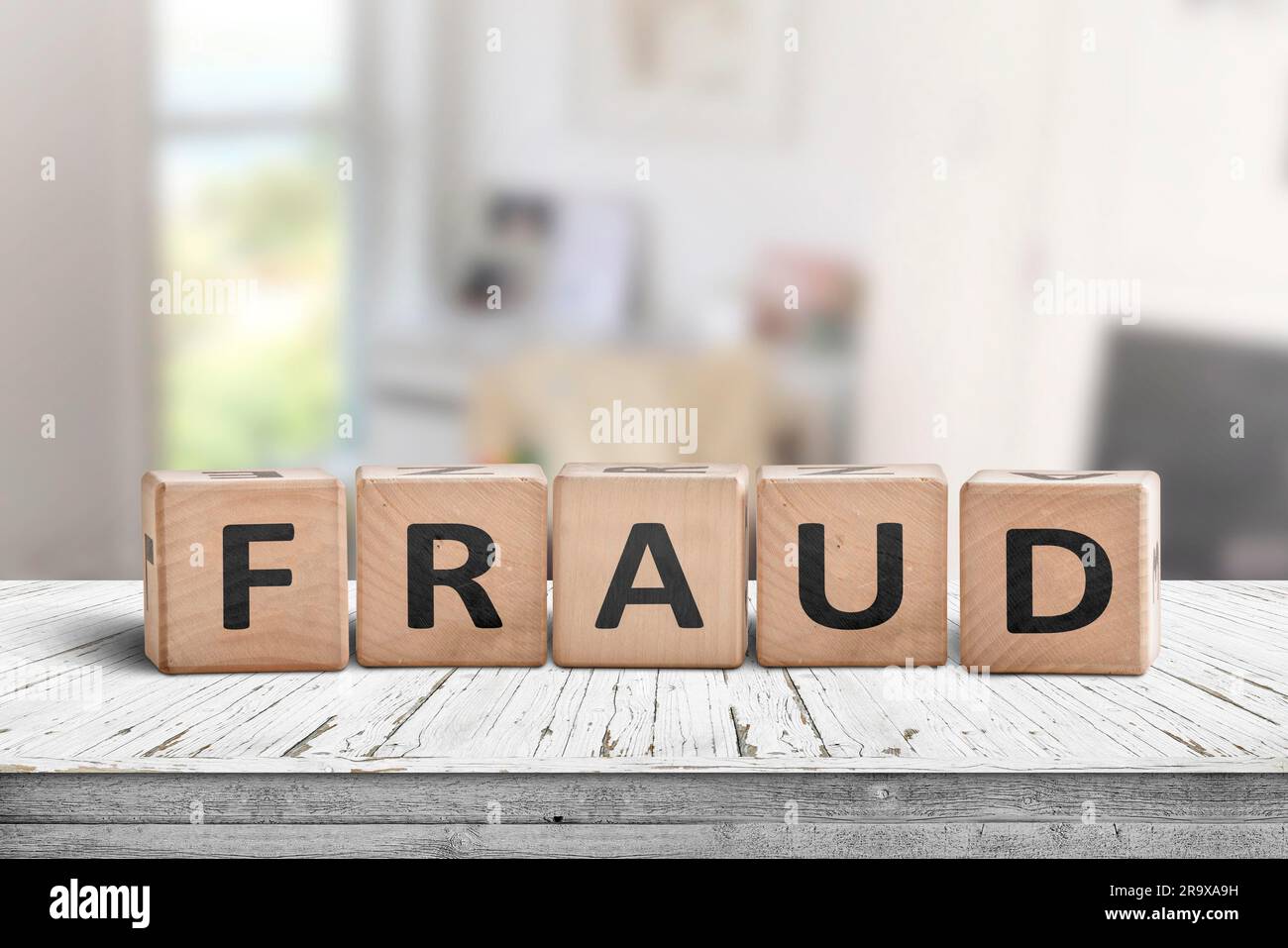 Fraud sign made of wooden blocks on a white desk in a bright room Stock ...