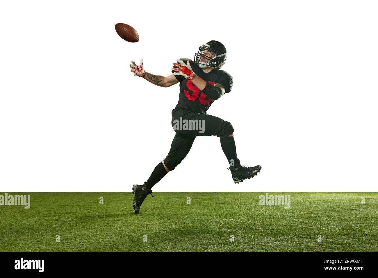 Concentrated man, american football player in black uniform in motion ...