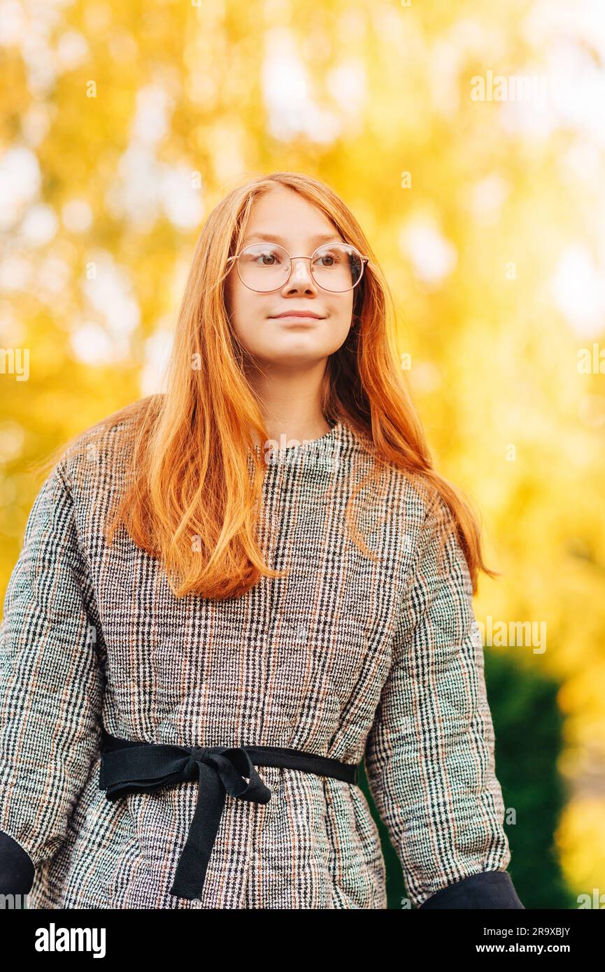Outdoor close up portrait of beautiful red-haired preteen girl wearing ...