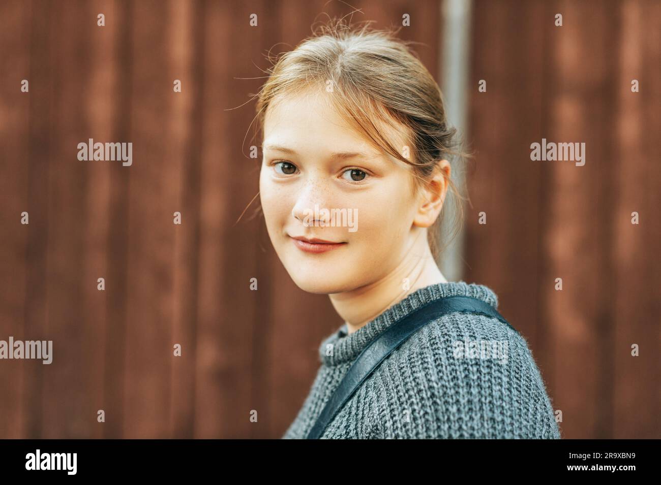 Outdoor close up portrait of young 10-11 year old girl with friendly ...