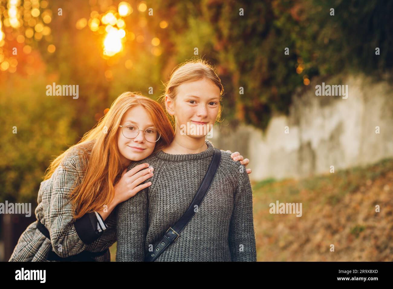 Outdoor sunset portrait of two young preteen girls Stock Photo - Alamy