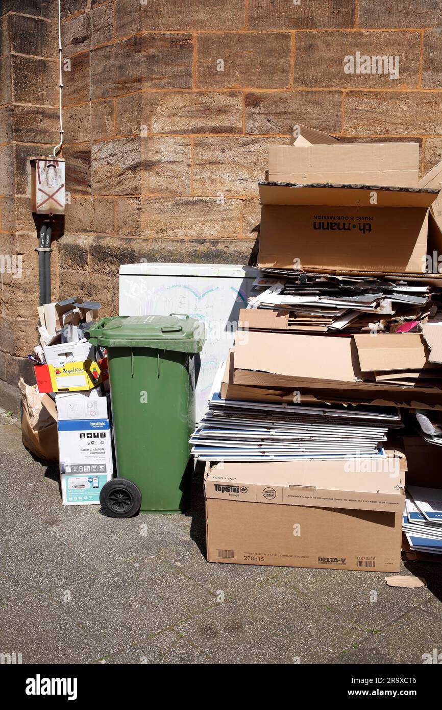 Cartons and stacks of waste paper, waste paper collection, green bin ...