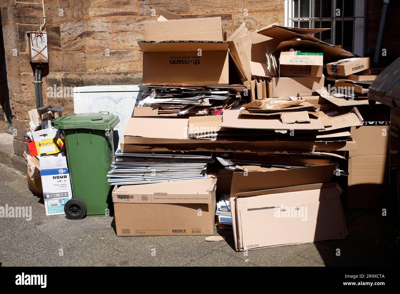 Cartons and stacks of waste paper, waste paper collection, green bin ...