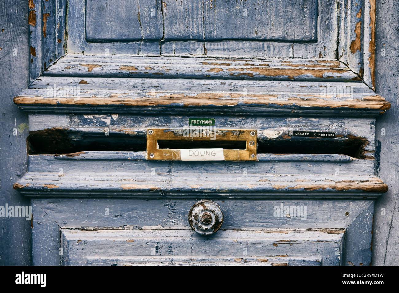 A door/letterbox in Bordeaux France that looks like it has been sun ...
