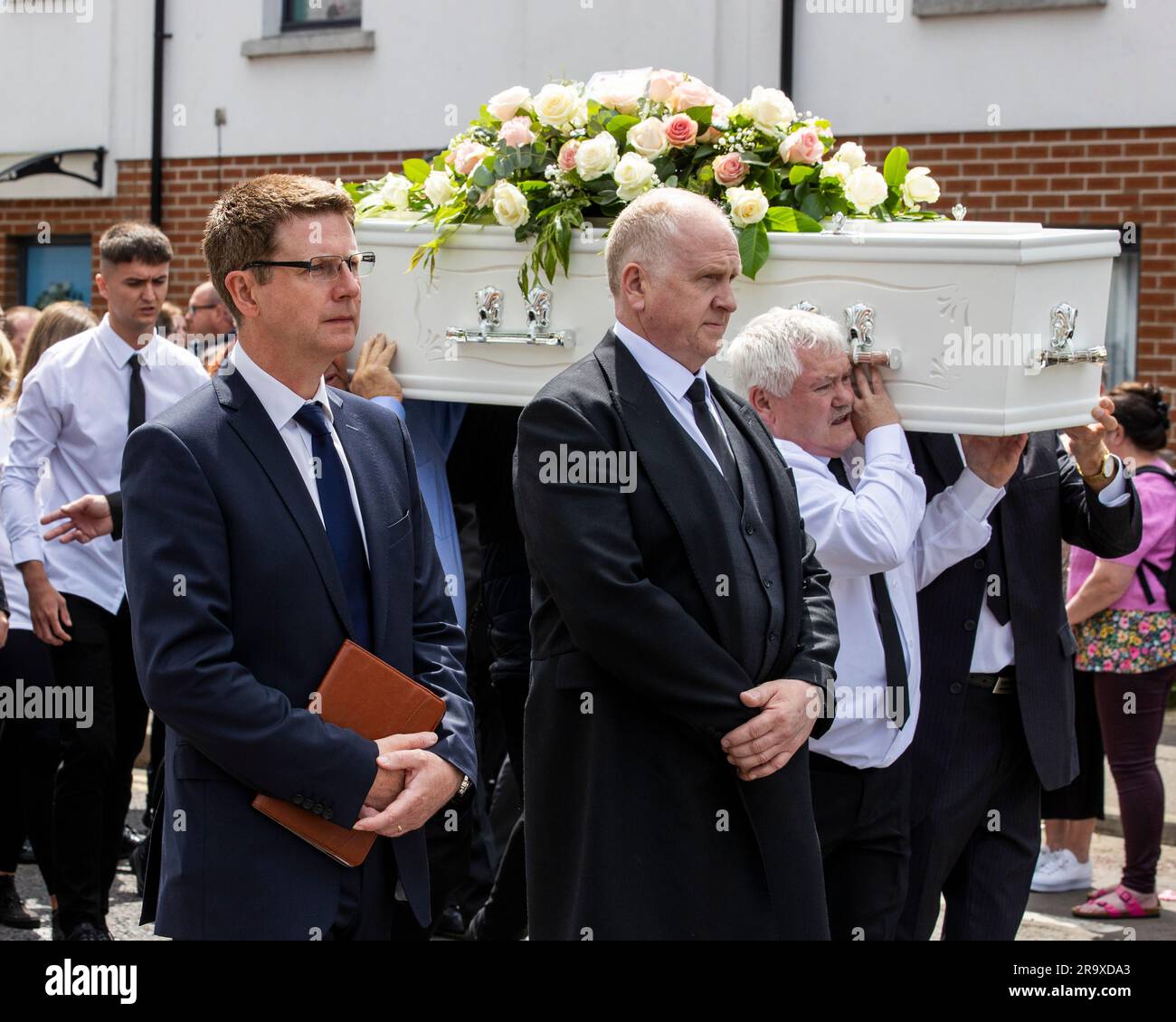 Rev Eddie Chestnutt (centre left) walks beside the coffin of Chloe ...