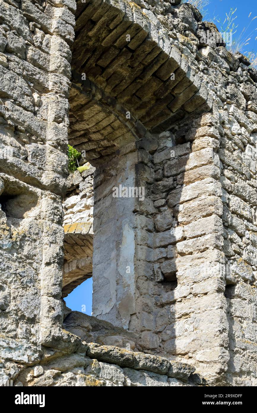 Arched window in an old dilapidated building. The texture of the ...